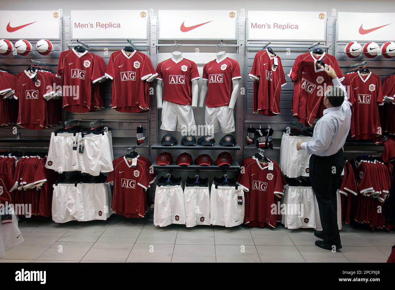 A Manchester United fan shops for a shirt from the Megastore display as ...