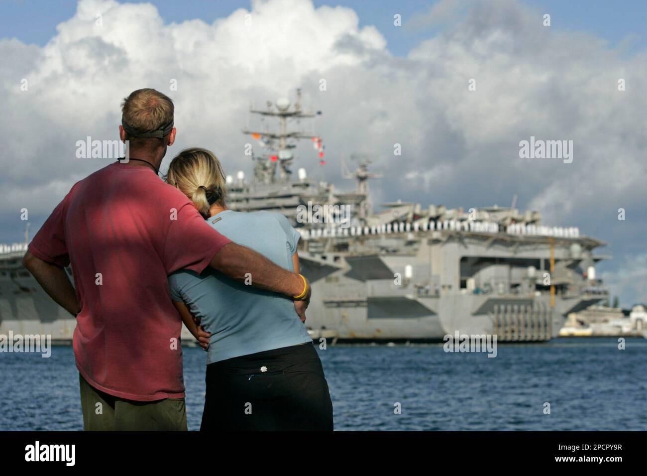 Brian Petit, right and his wife Jodi watch the USS Abraham Lincoln as ...