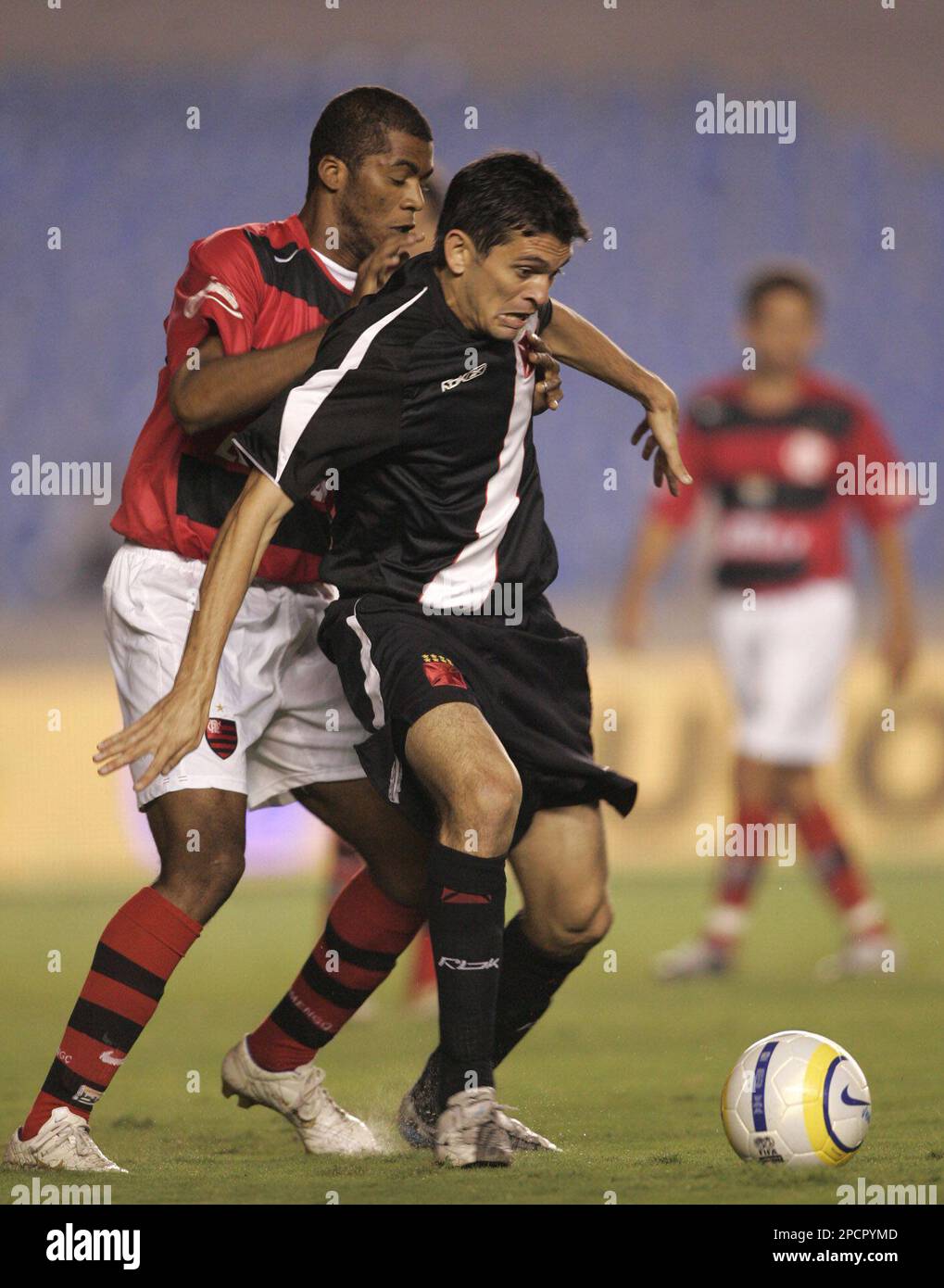 Flamengo soccer player Fernando, left, fights for the ball with Vasco's ...
