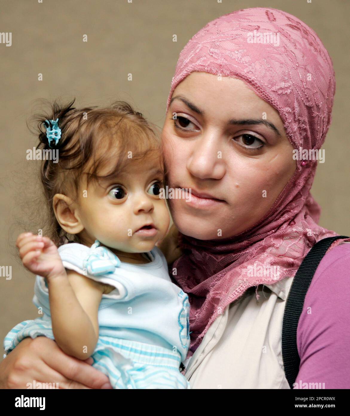 Hala Awad, right, holds her 9-month-old daughter Halla after a news ...