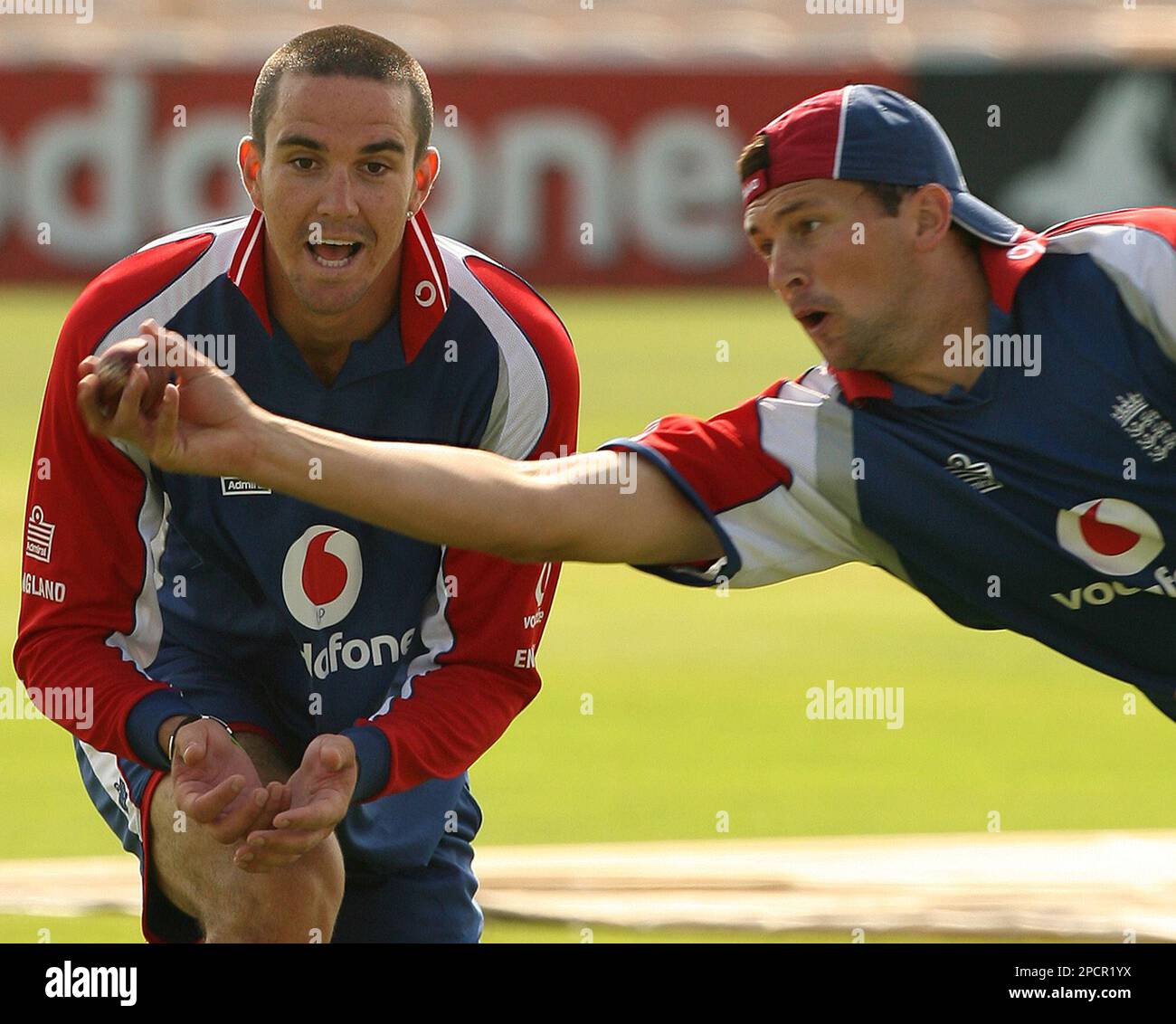 England's Steve Harmison, right, takes a catch as teammate Kevin ...
