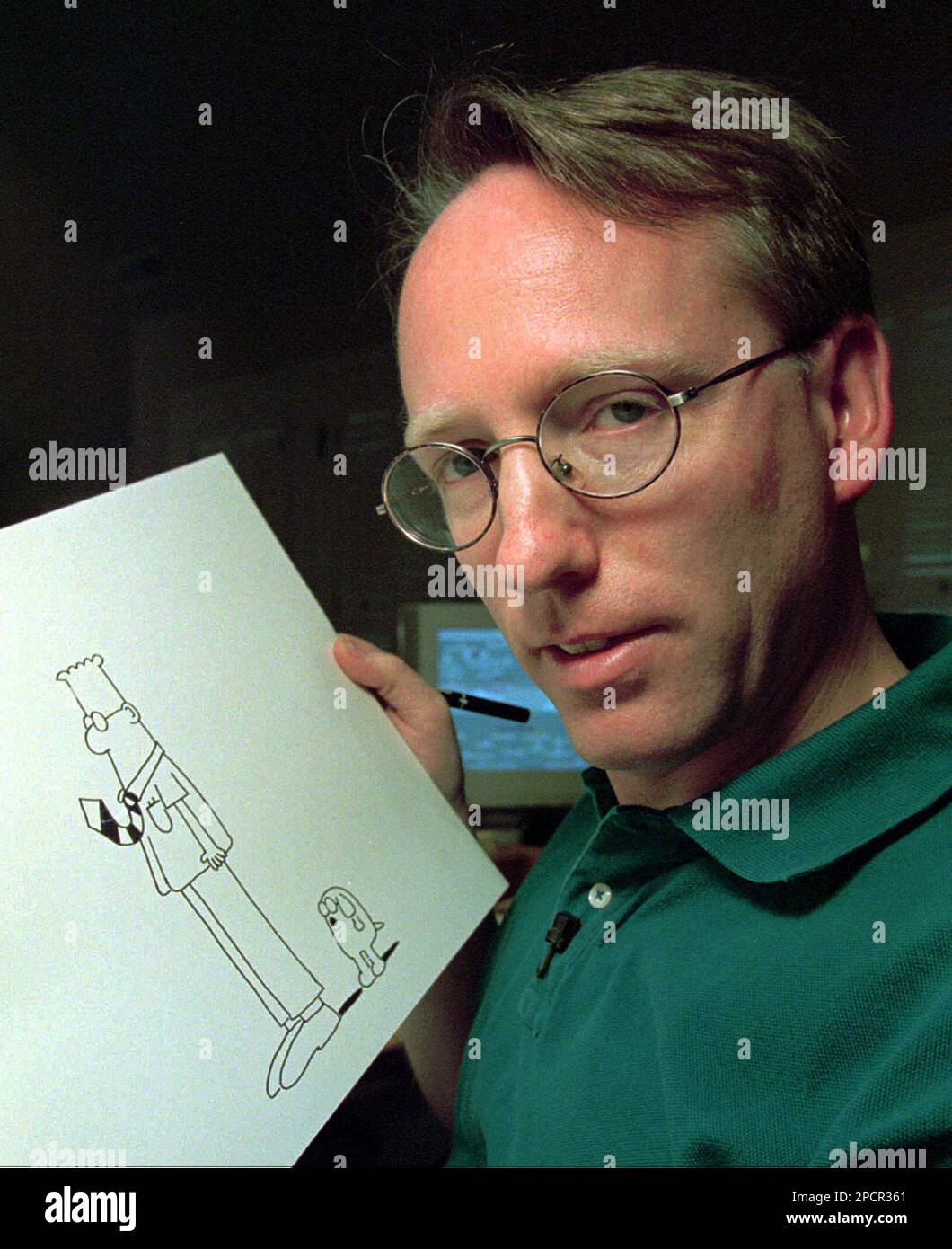 ** FILE ** Scott Adams, creator of the comic strip "Dilbert," holds an ...