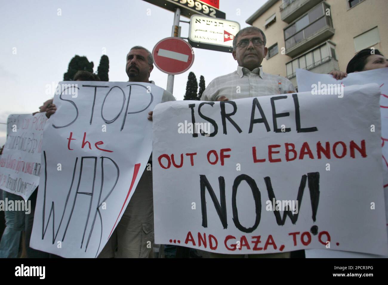 Israeli left wing activist hold banners against the ongoing military ...