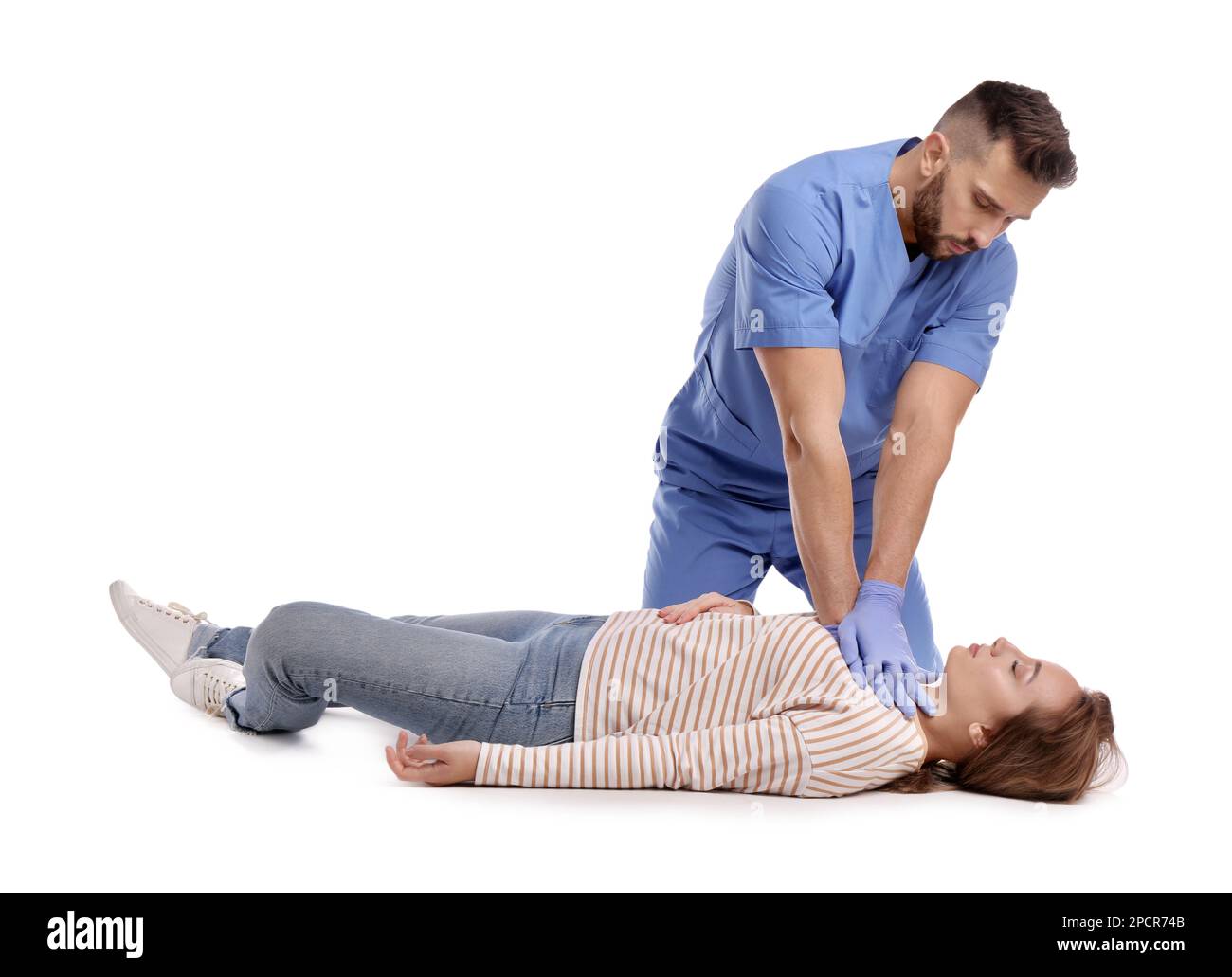 Doctor in uniform performing first aid on unconscious woman against ...