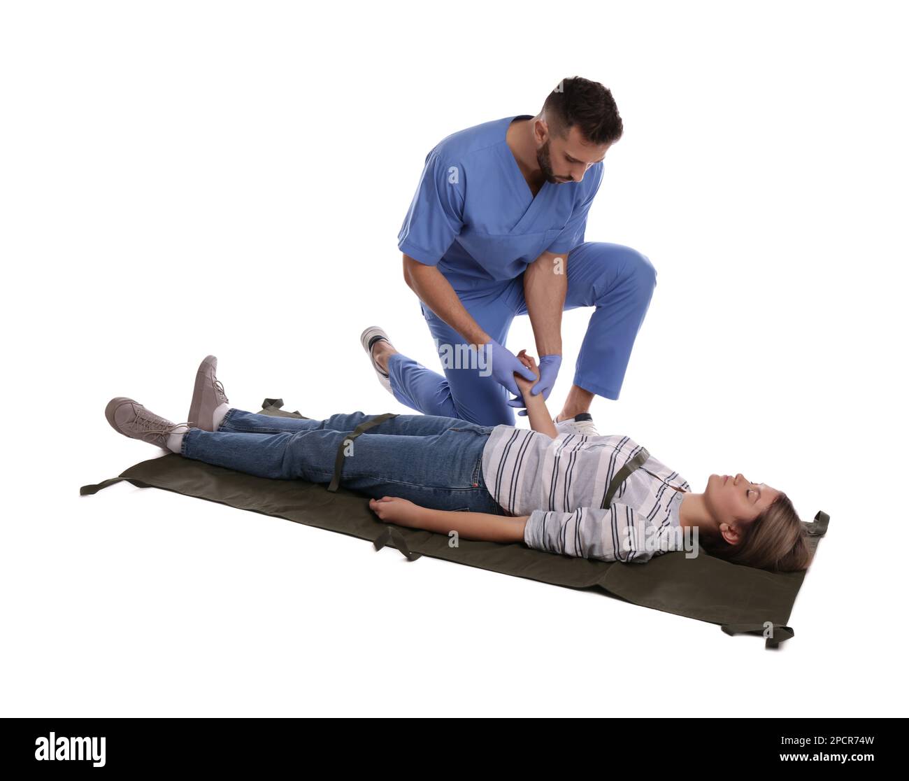 Doctor in uniform fixing woman on stretcher Stock Photo - Alamy