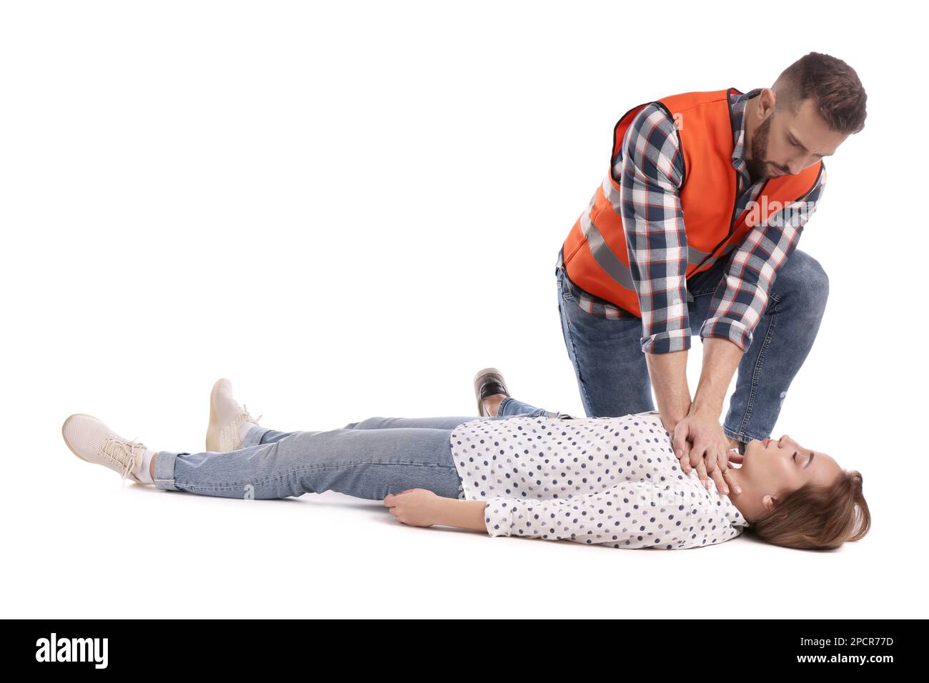 Paramedic in uniform performing first aid on unconscious woman against ...
