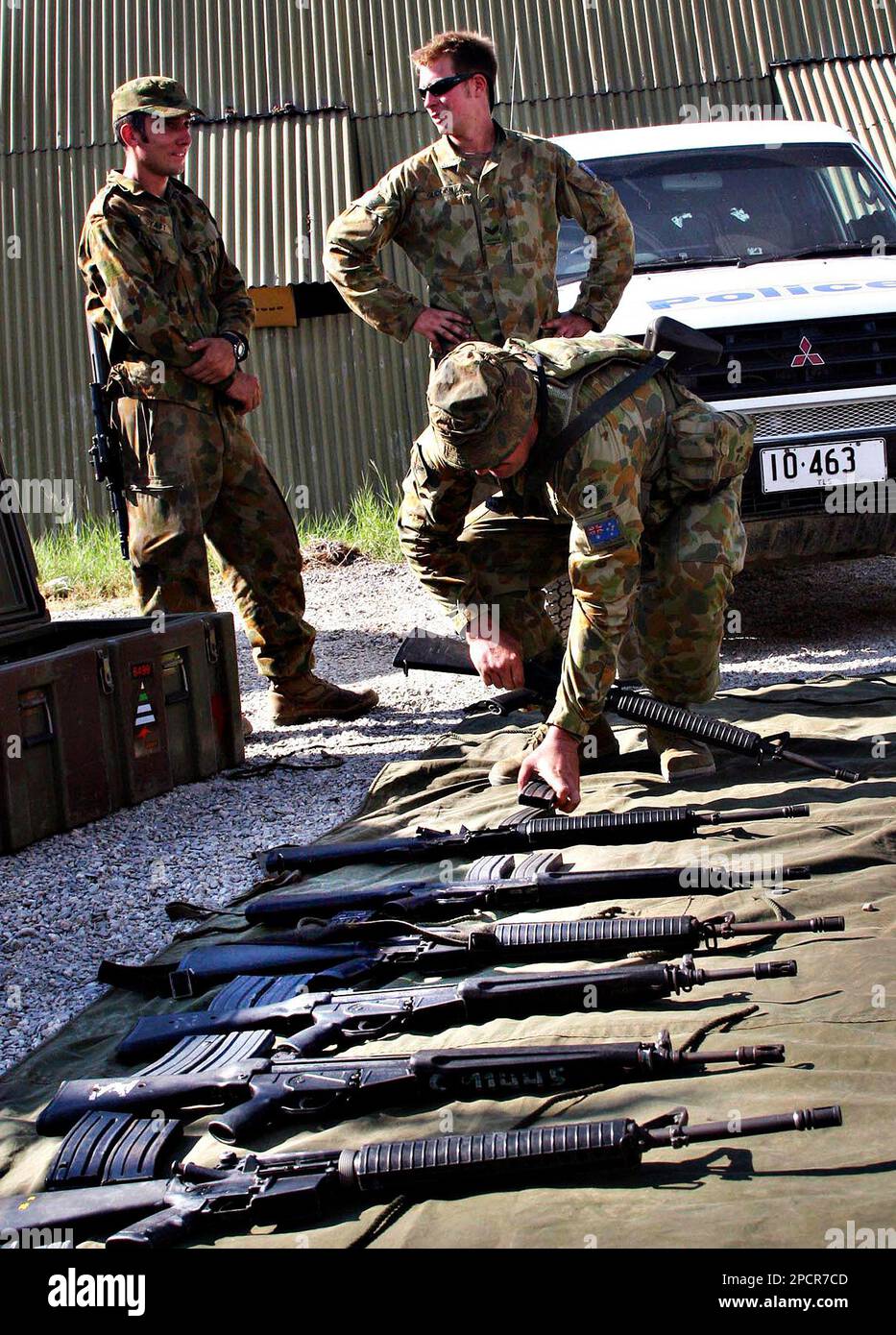 Australian soldiers display weapons surrendered by a militia group ...