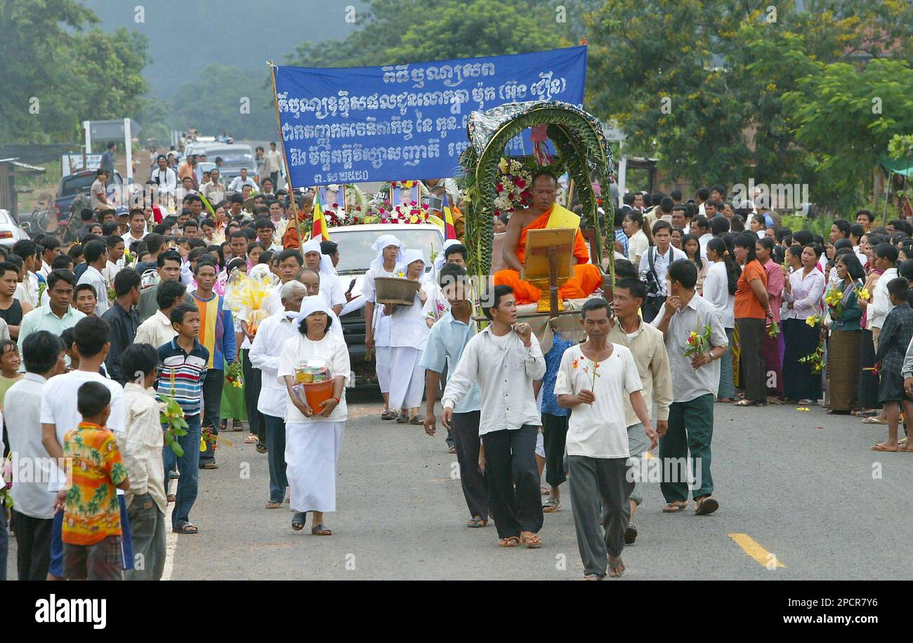 Relatives and friends walk in the funeral procession for former Khmer ...