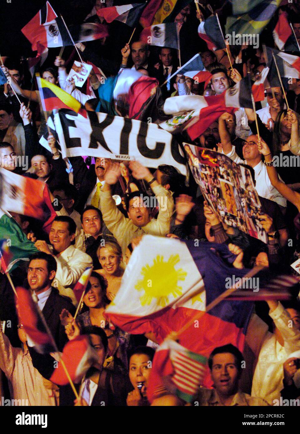 Audience members cheer during the Miss Universe 2006 pageant on Sunday ...