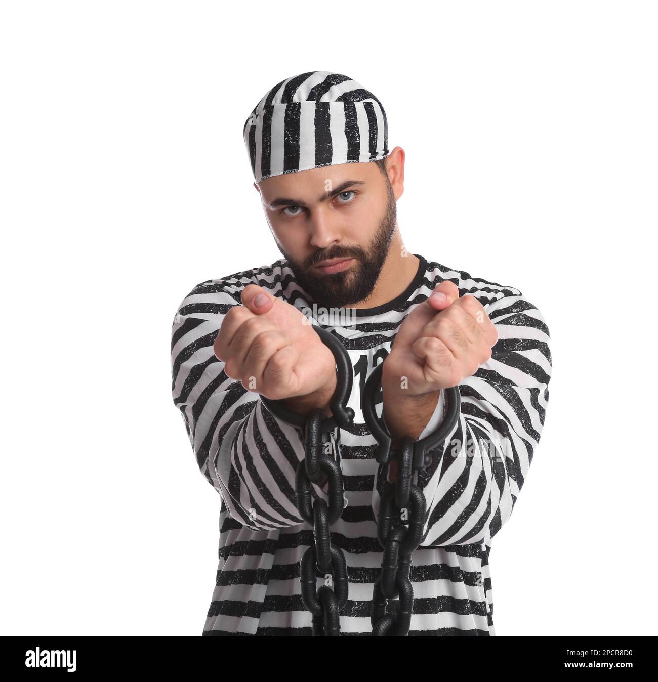 Prisoner in special uniform with chained hands on white background ...