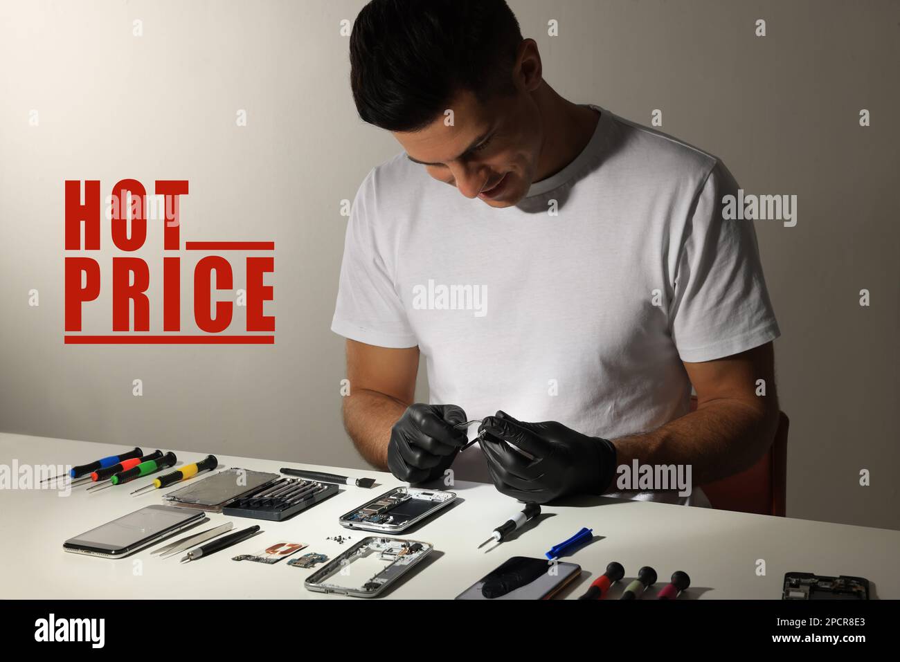 Smartphone repairing by hot price. Man repairing broken mobile at table ...
