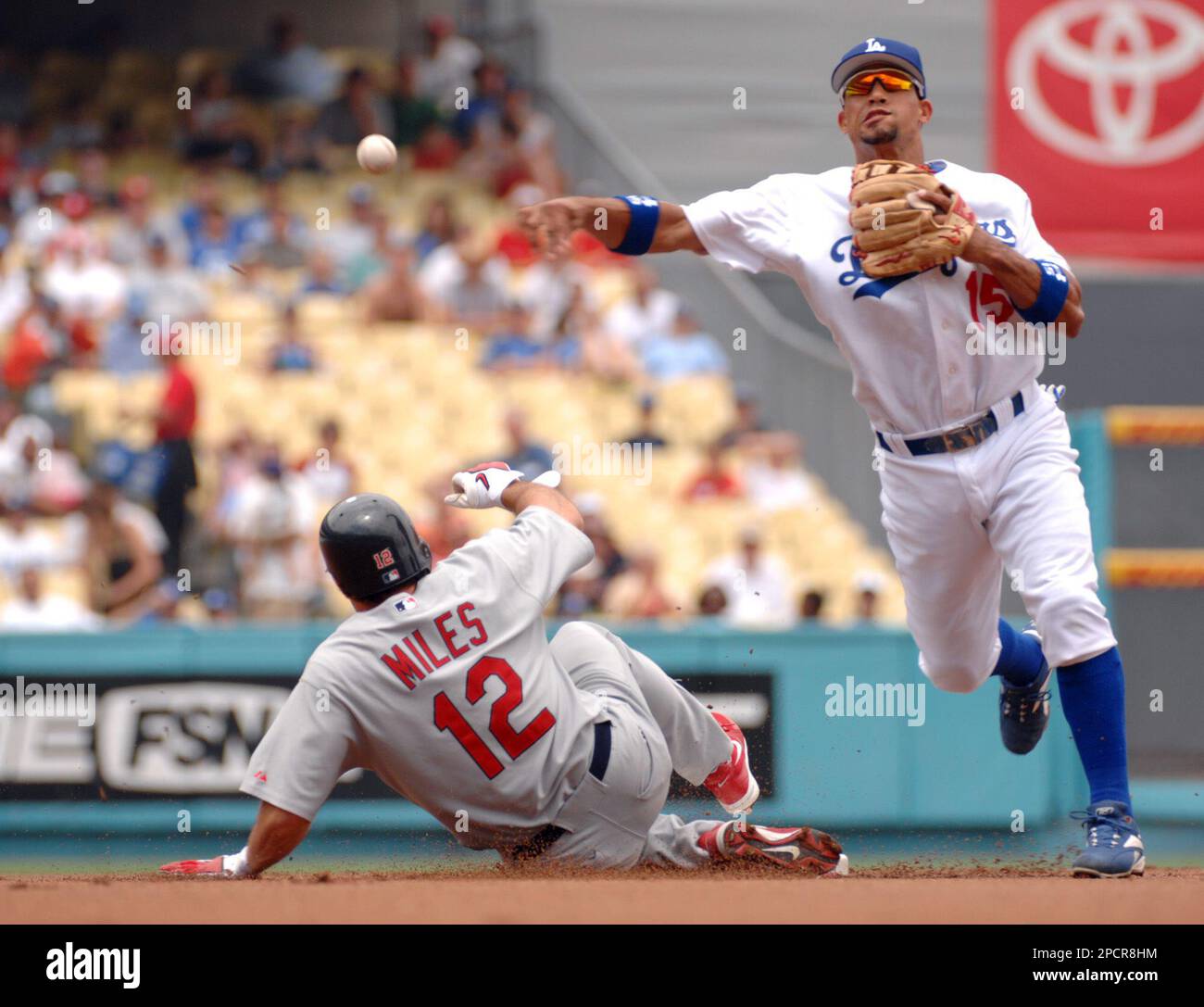 St. Louis Cardinals' Aaron Miles breaks up the double play as Los ...