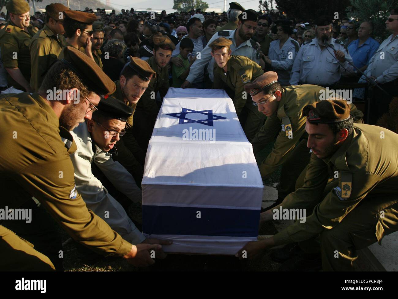 Israeli soldiers place the coffin of Liran Sa'adiya into a grave in ...