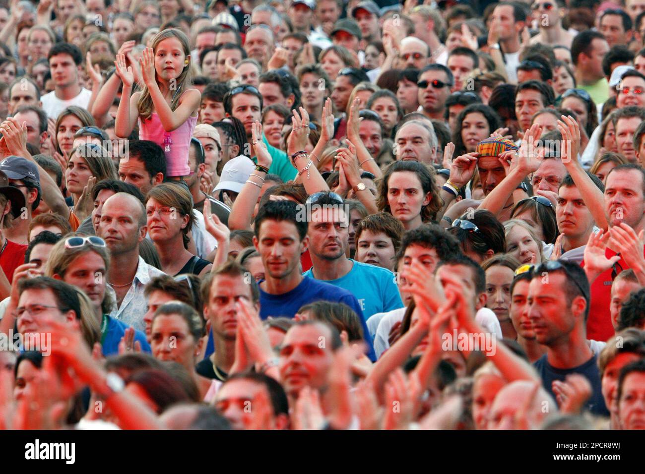 Fans of French singer Raphael stand in front of the main stage during ...