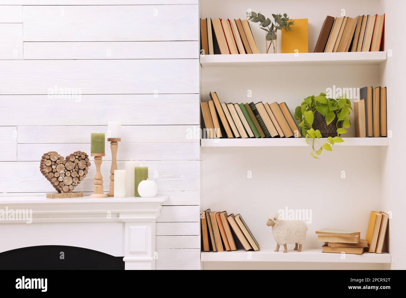 Collection of books and decor elements on shelves indoors Stock Photo ...