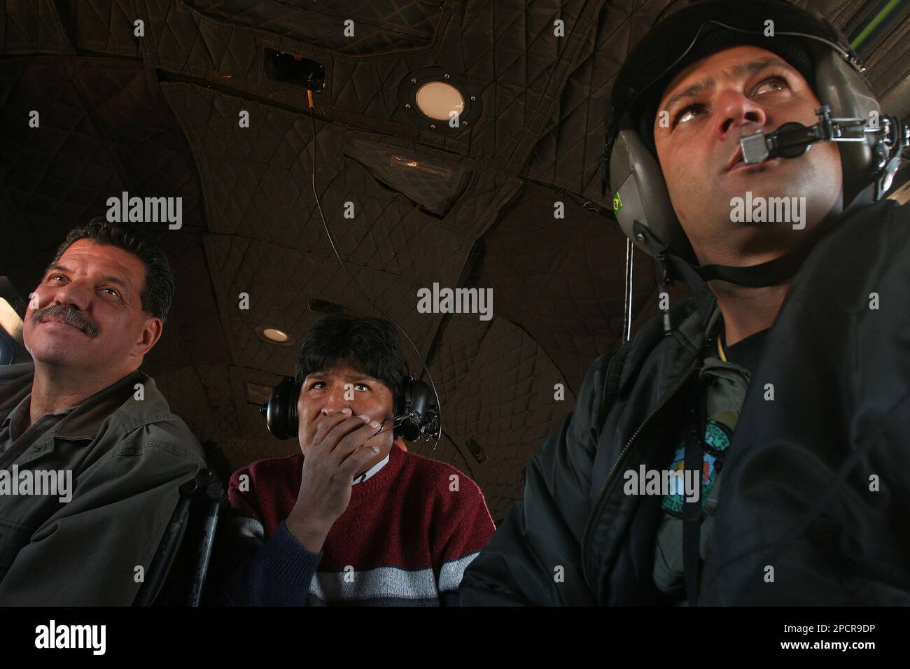 Surrounded by Venezuelan ambassador Julio Montes, left, and a ...