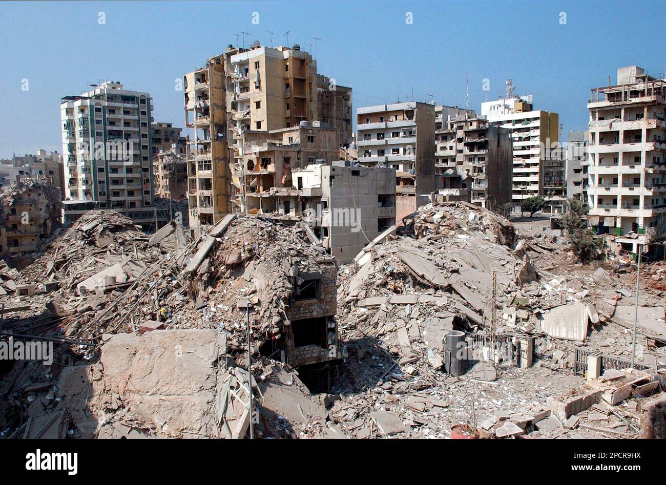 Collapsed apartment buildings are seen in the Hezbollah stronghold of ...