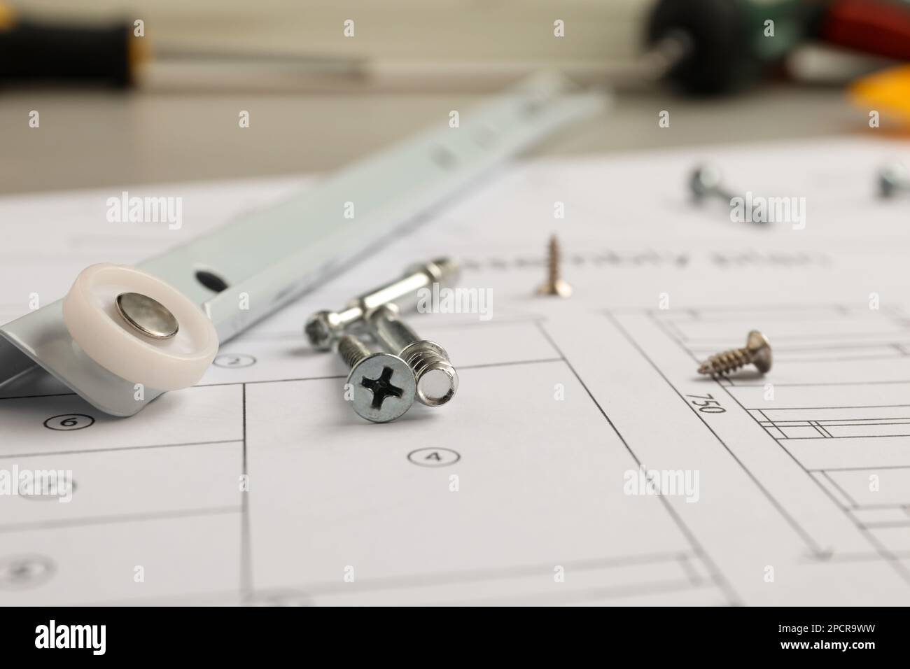 Drawer slide, plan and different fasteners on table, closeup. Furniture ...
