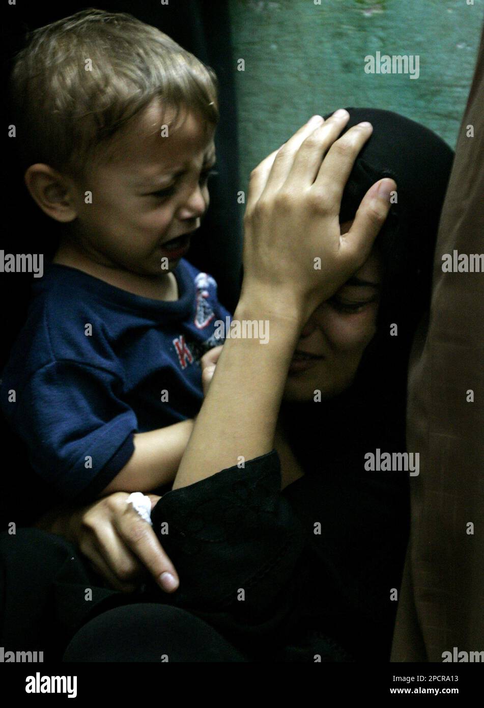 Palestinian Mona Abu Awad, holding her nephew, mourns during the ...