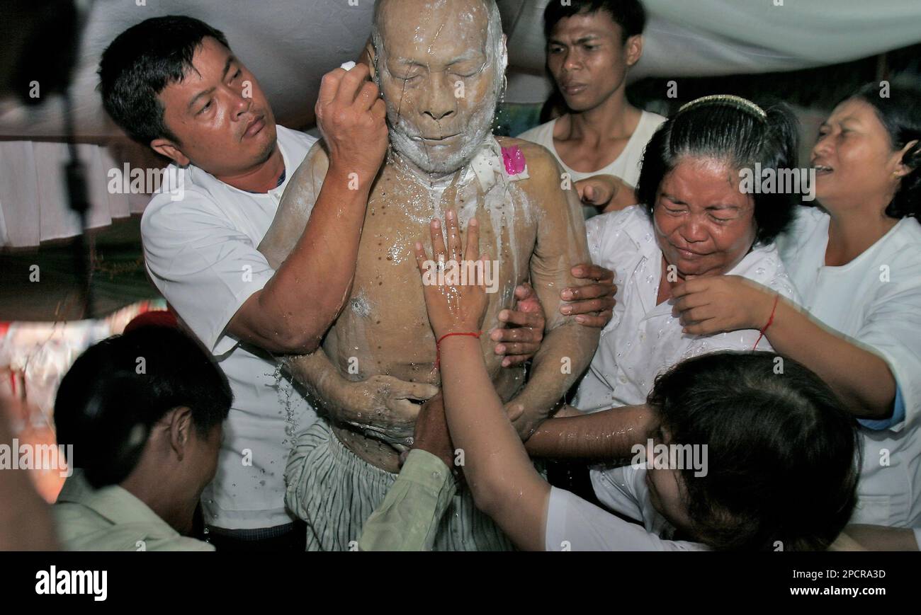 The body of former Khmer Rouge chief Ta Mok is prepared for burial by ...