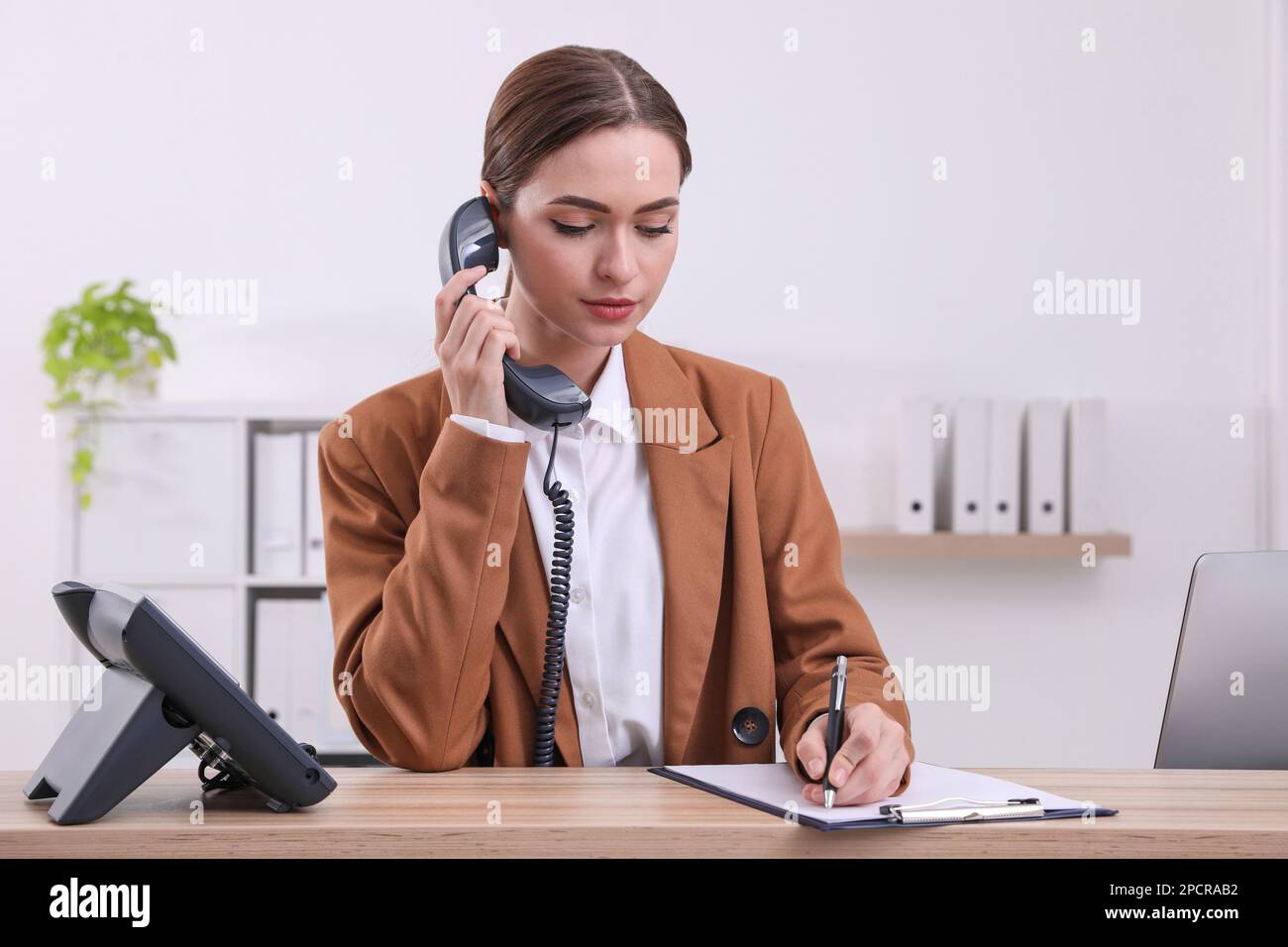 Busy receptionist hi-res stock photography and images - Alamy