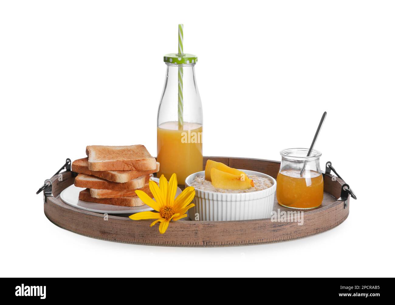 Wooden tray with delicious breakfast and beautiful flower on white ...