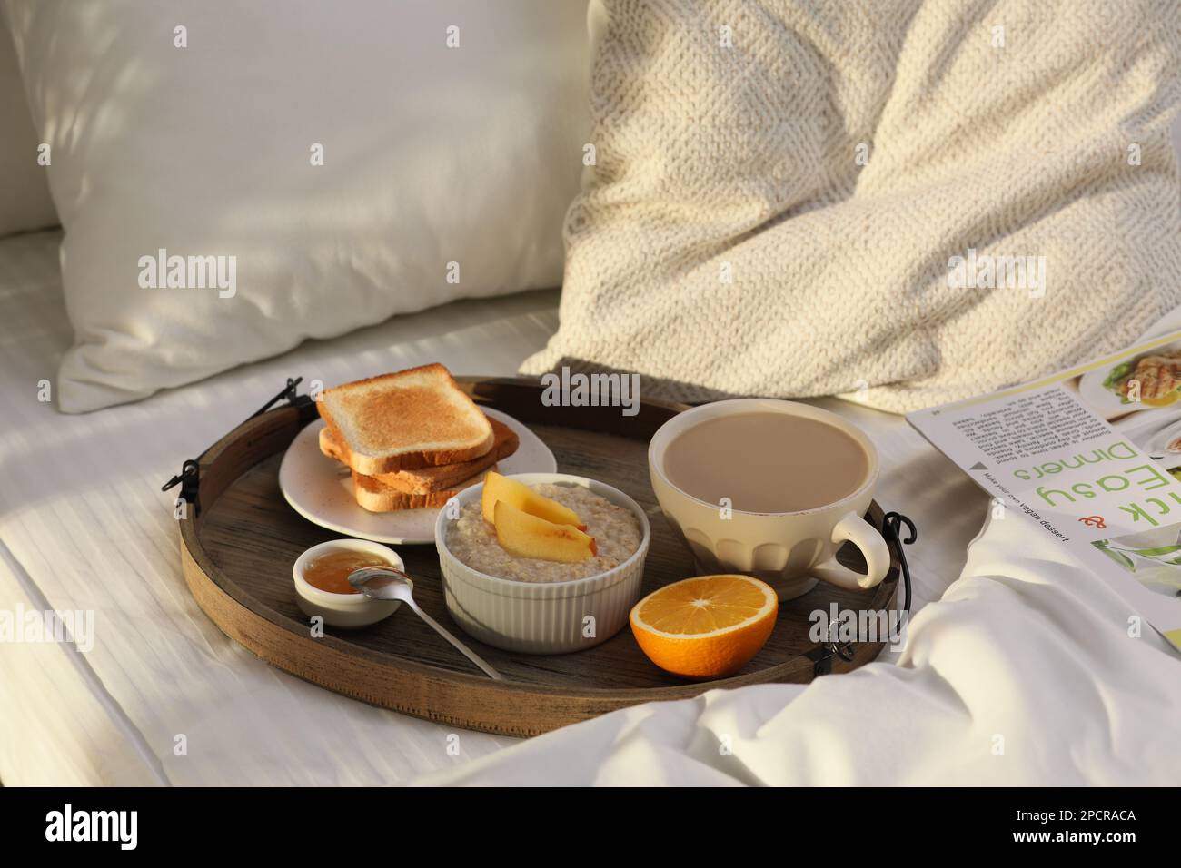 Wooden tray with delicious breakfast on bed in morning Stock Photo - Alamy