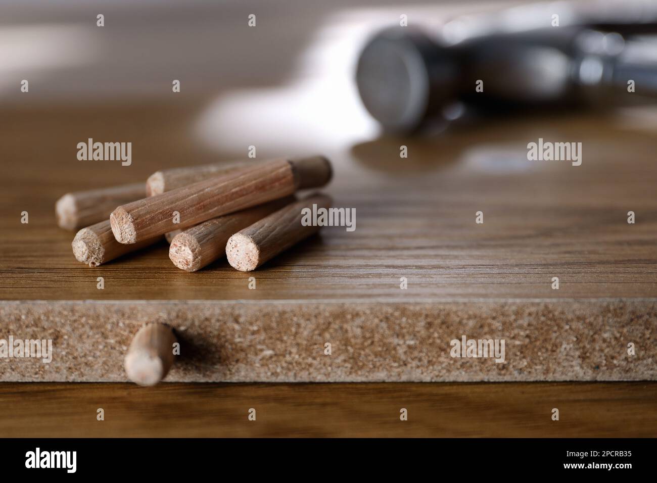 Wooden furniture parts and pile of dowels, closeup. Self-assembly Stock ...