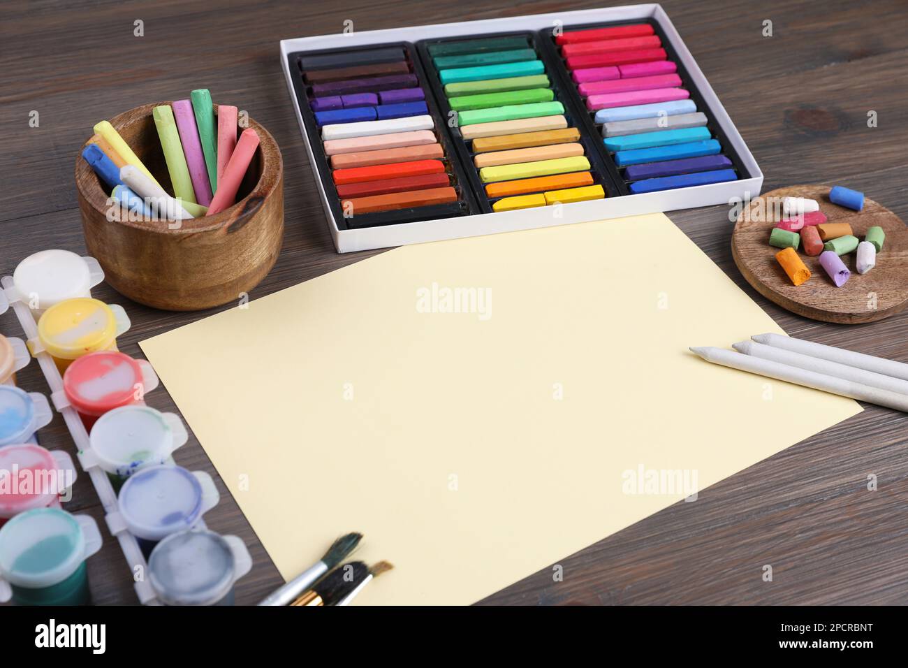 Blank sheet of paper, colorful chalk pastels and other drawing tools on ...