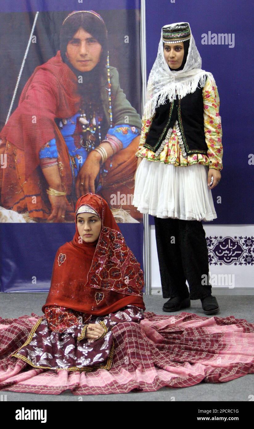 Models wear Iranian traditional dresses presented during a fashion show ...