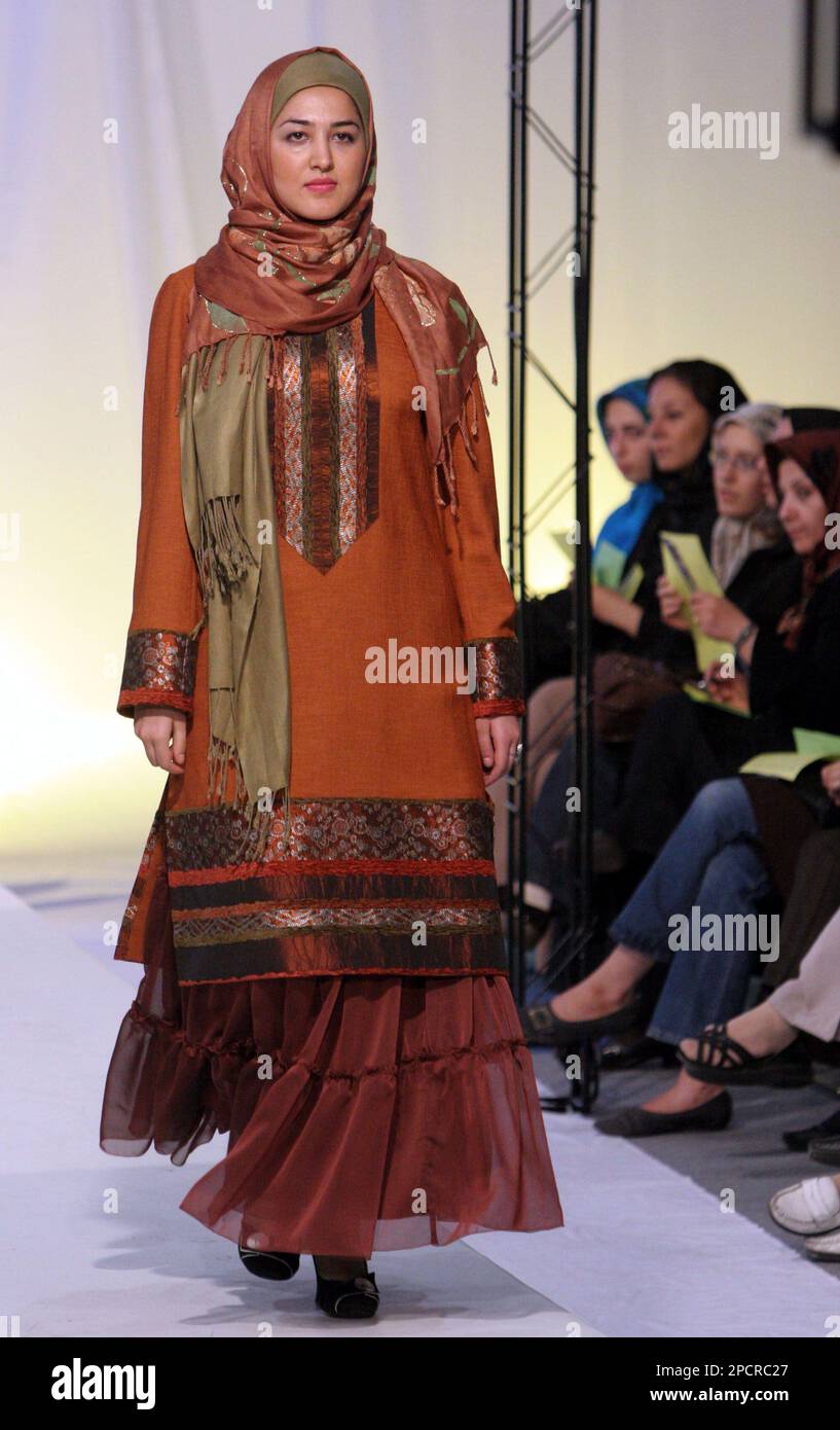 A model presents an Iranian traditional dress with Islamic code, at a ...