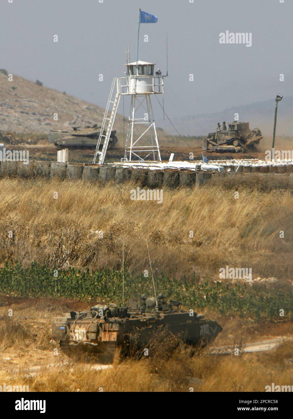 Israeli armored vehicles drive near a United Nations base inside ...