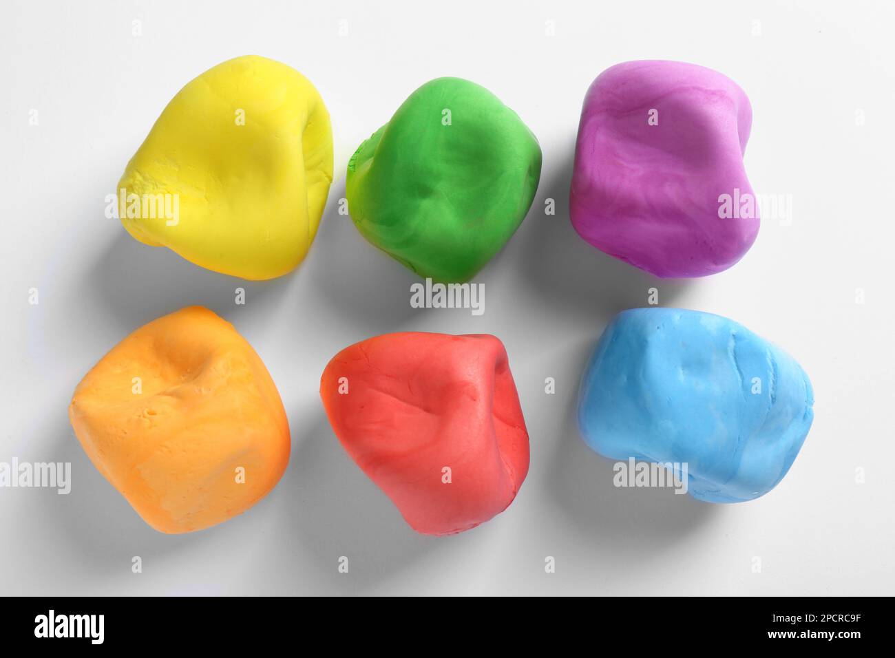 Different color play dough on white background, top view Stock Photo ...