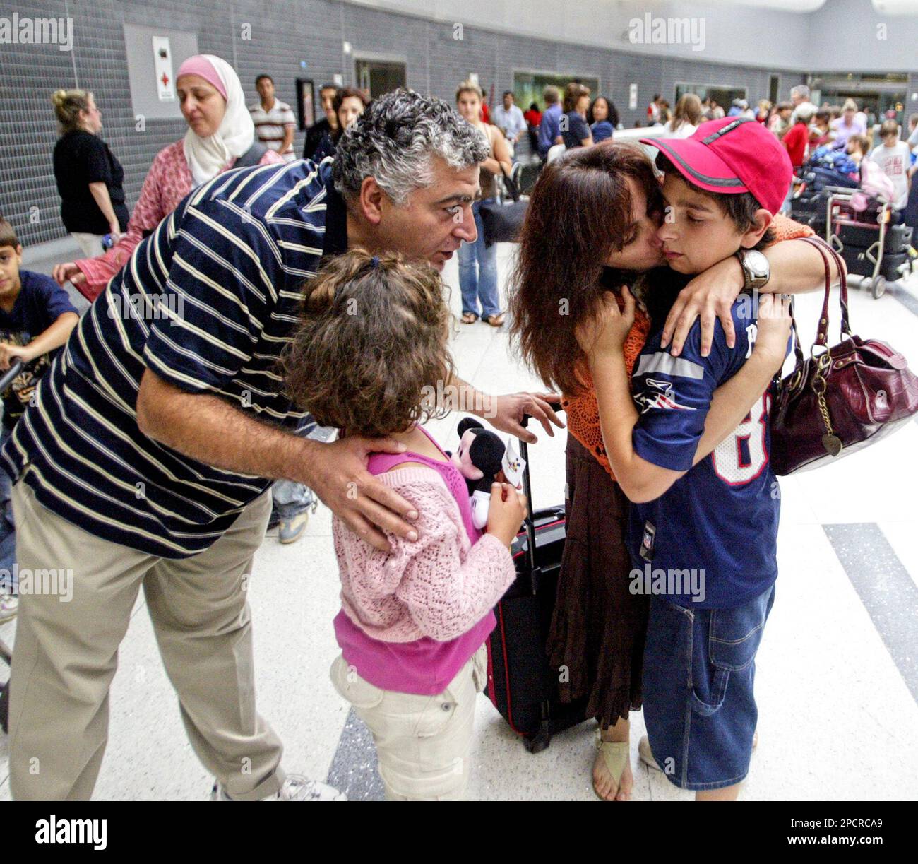 Mohammad Haidar, left, and Reem Haidar, right, of Boston, greet their ...