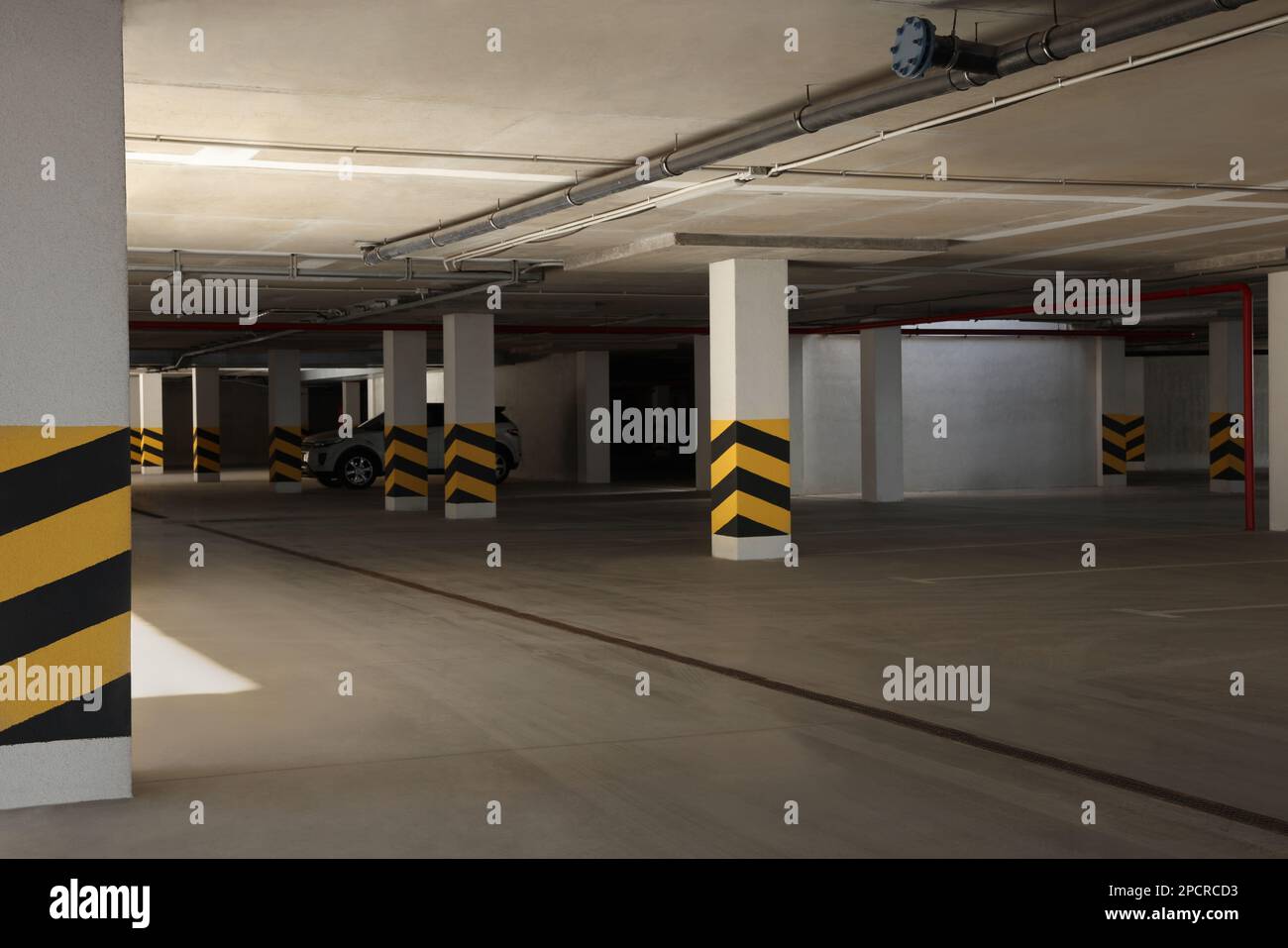Car parking garage with warning stripes on columns Stock Photo - Alamy