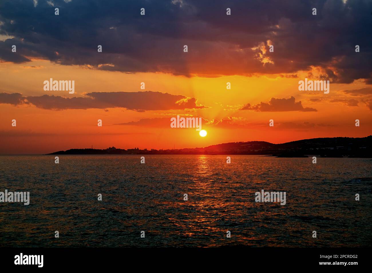 Sea sunset. Vanilla orange sky at sunset with clouds and calm sea ...