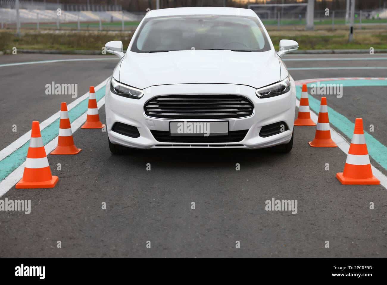 Modern car on driving school test track with traffic cones Stock Photo ...