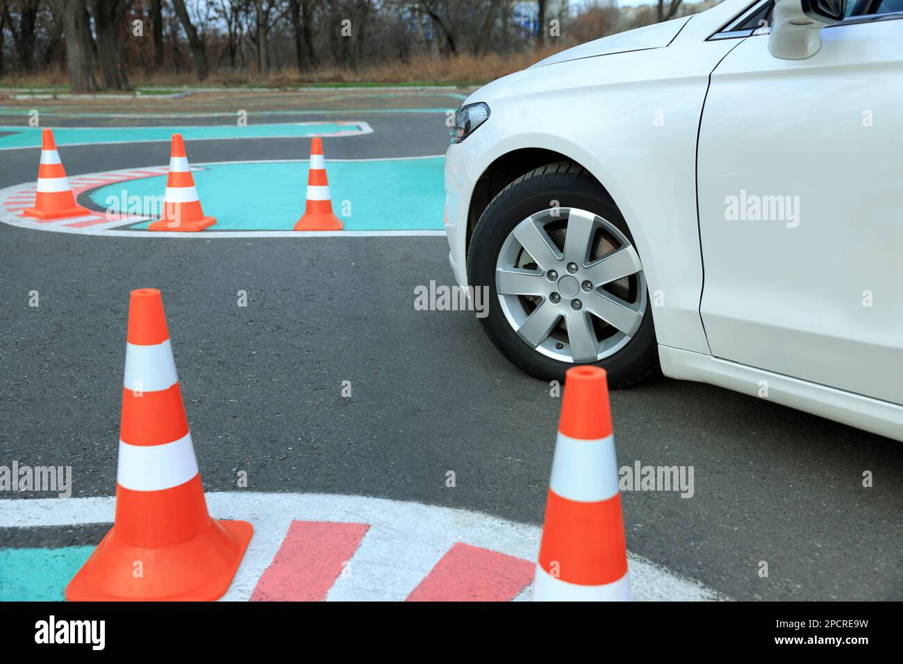 Modern car on test track with traffic cones, closeup. Driving school ...