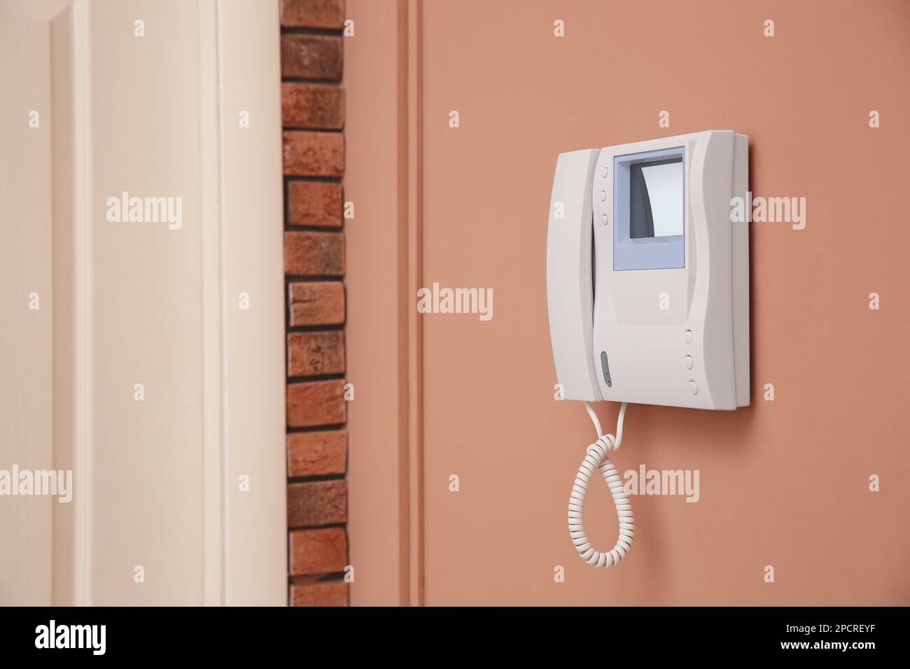 Modern intercom system with handset on beige wall, space for text Stock ...
