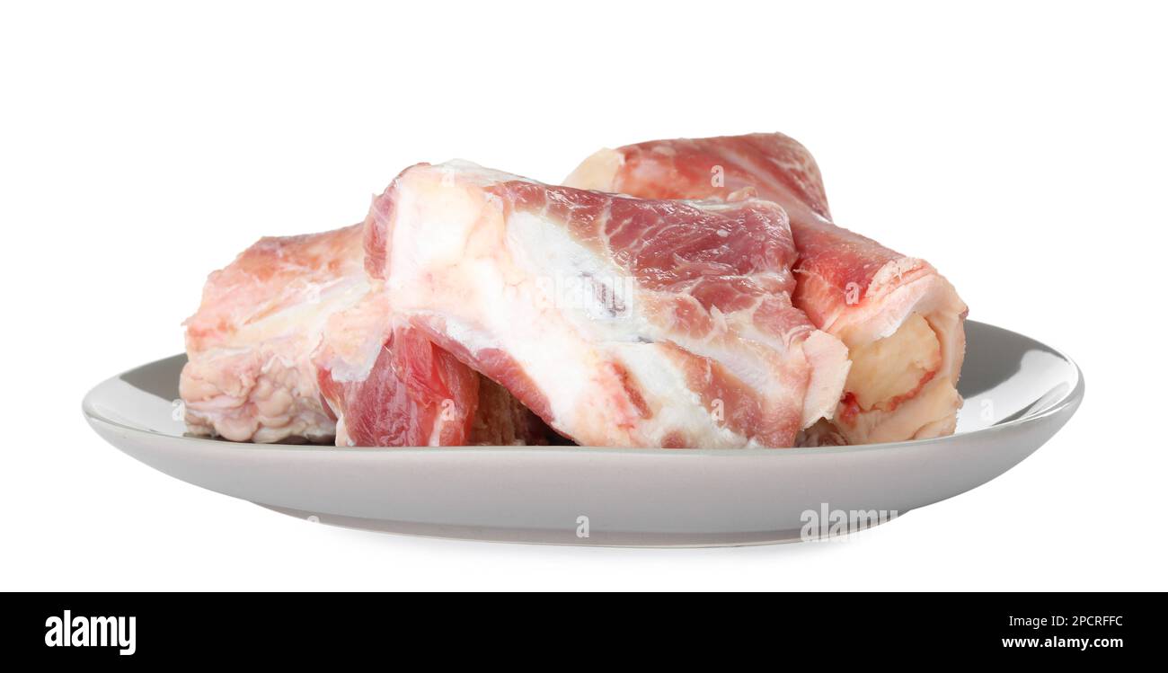Plate with raw chopped meaty bones isolated on white Stock Photo - Alamy