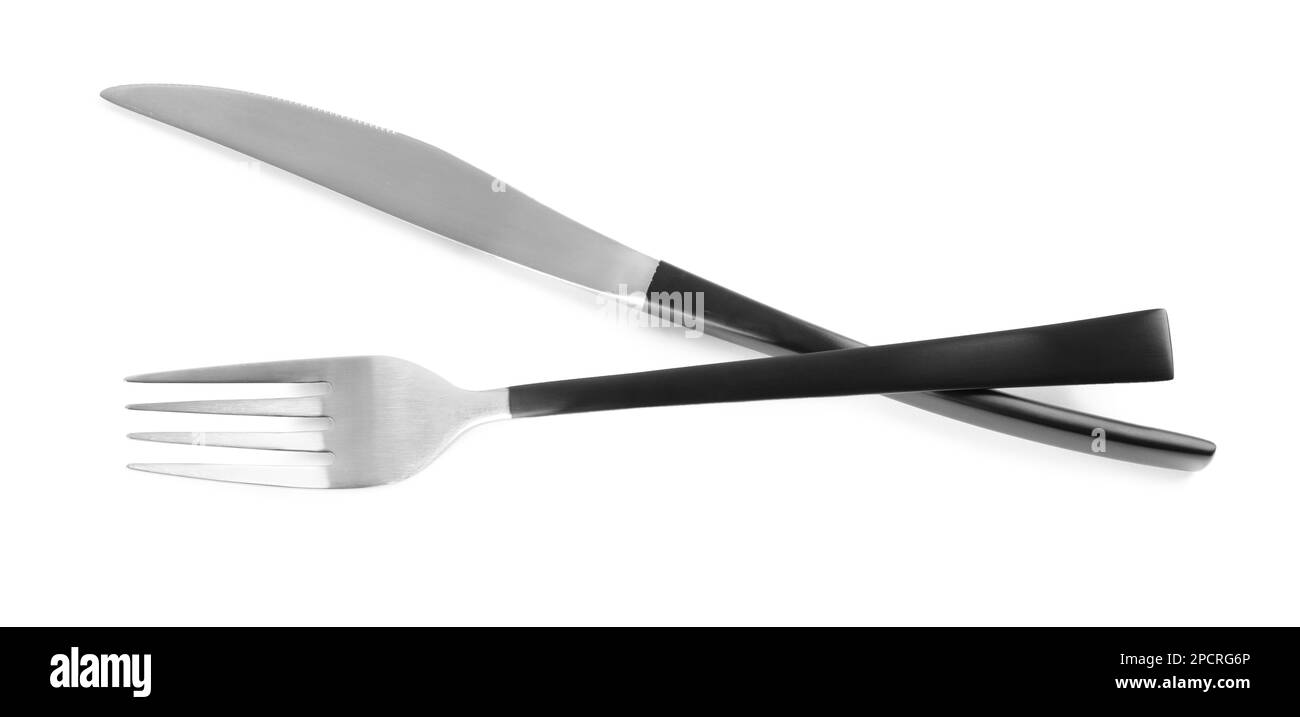New fork and knife with black handles on white background, top view ...