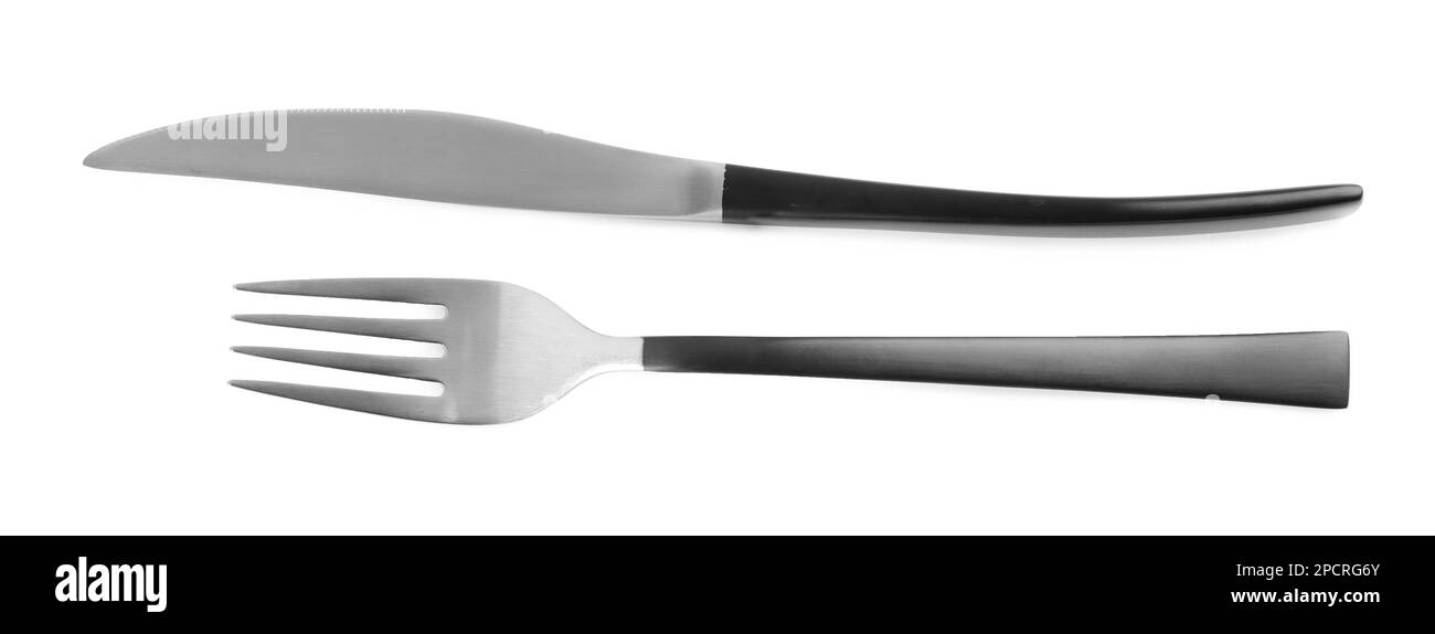 New fork and knife with black handles on white background, top view ...