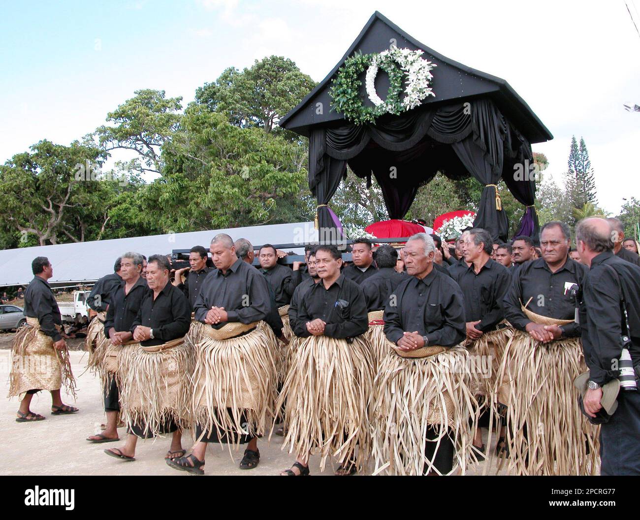 Pallbearers carry the caskets of Tongan Prince Tu'ipelehake and his ...