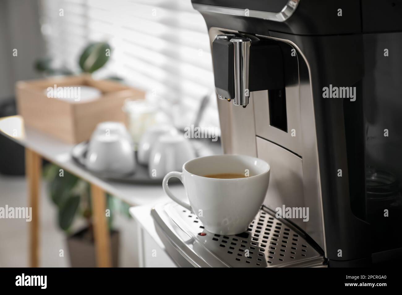 Modern coffee machine with cup in office. Space for text Stock Photo ...