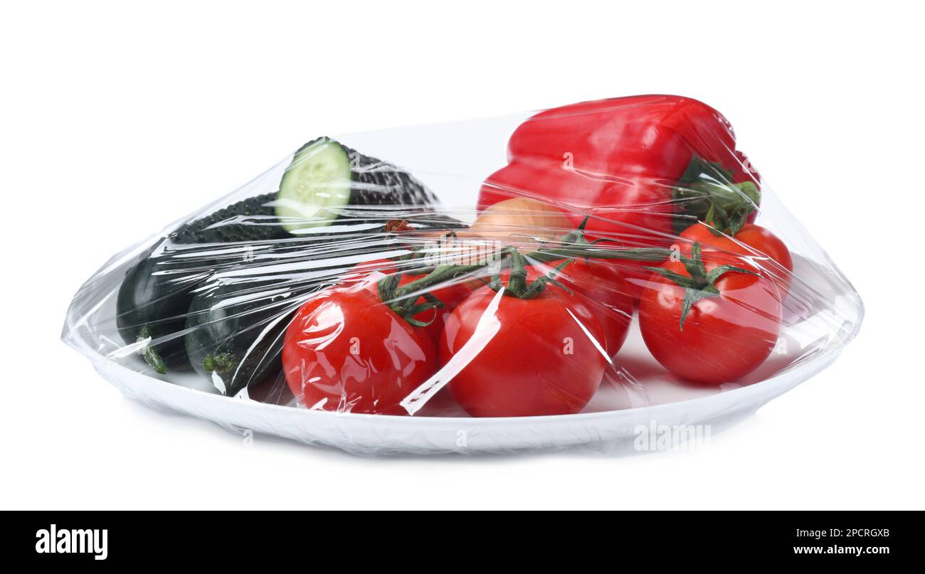 Plate of fresh vegetables wrapped with transparent plastic stretch film ...