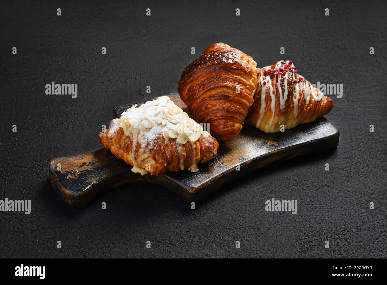 Assortment of crispy croissants on serving board Stock Photo - Alamy