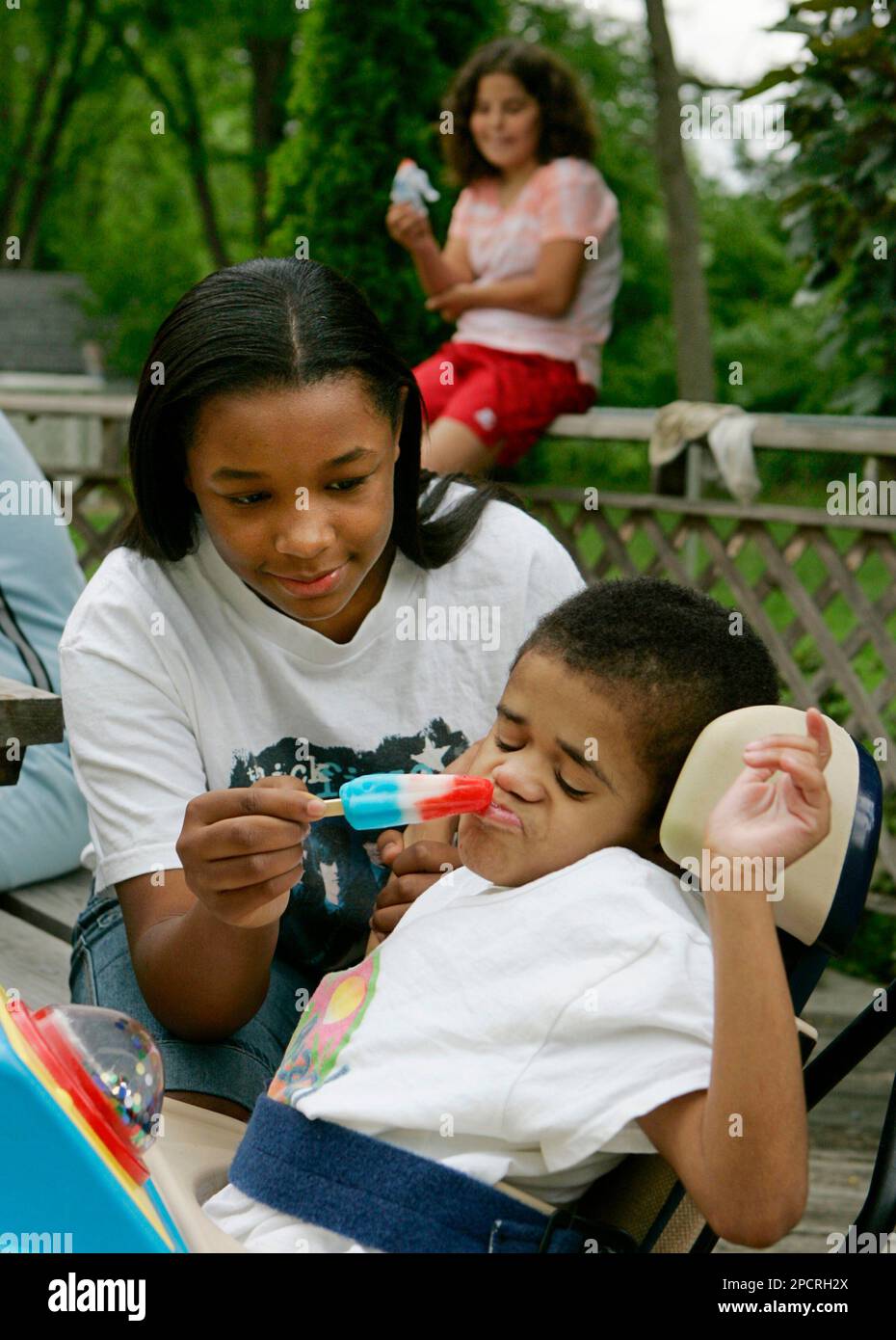 Shonda Schultz, center, offers a treat to her sister, Taysha, as Emily ...