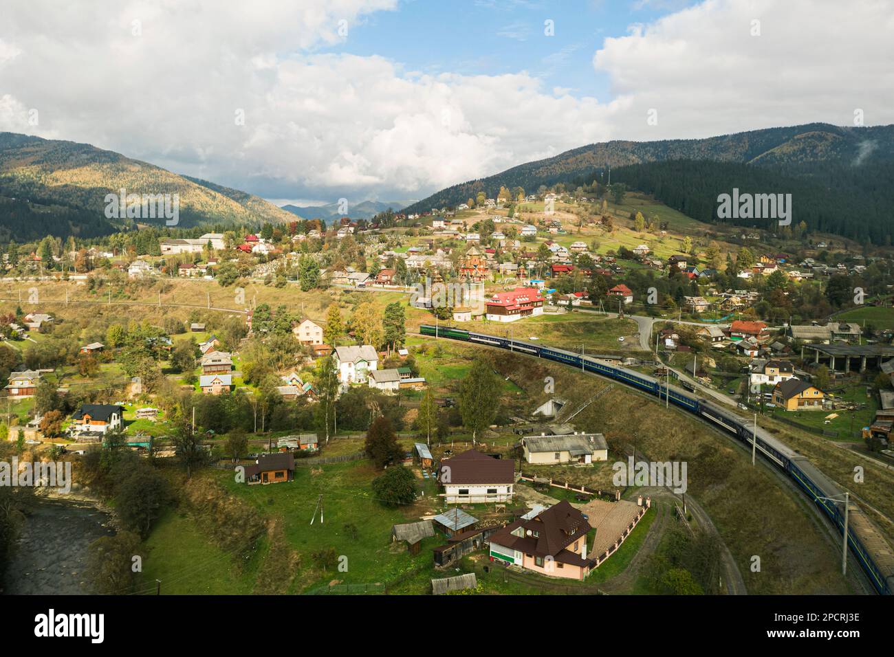 Aerial view of train on bridge and mountain village Stock Photo - Alamy