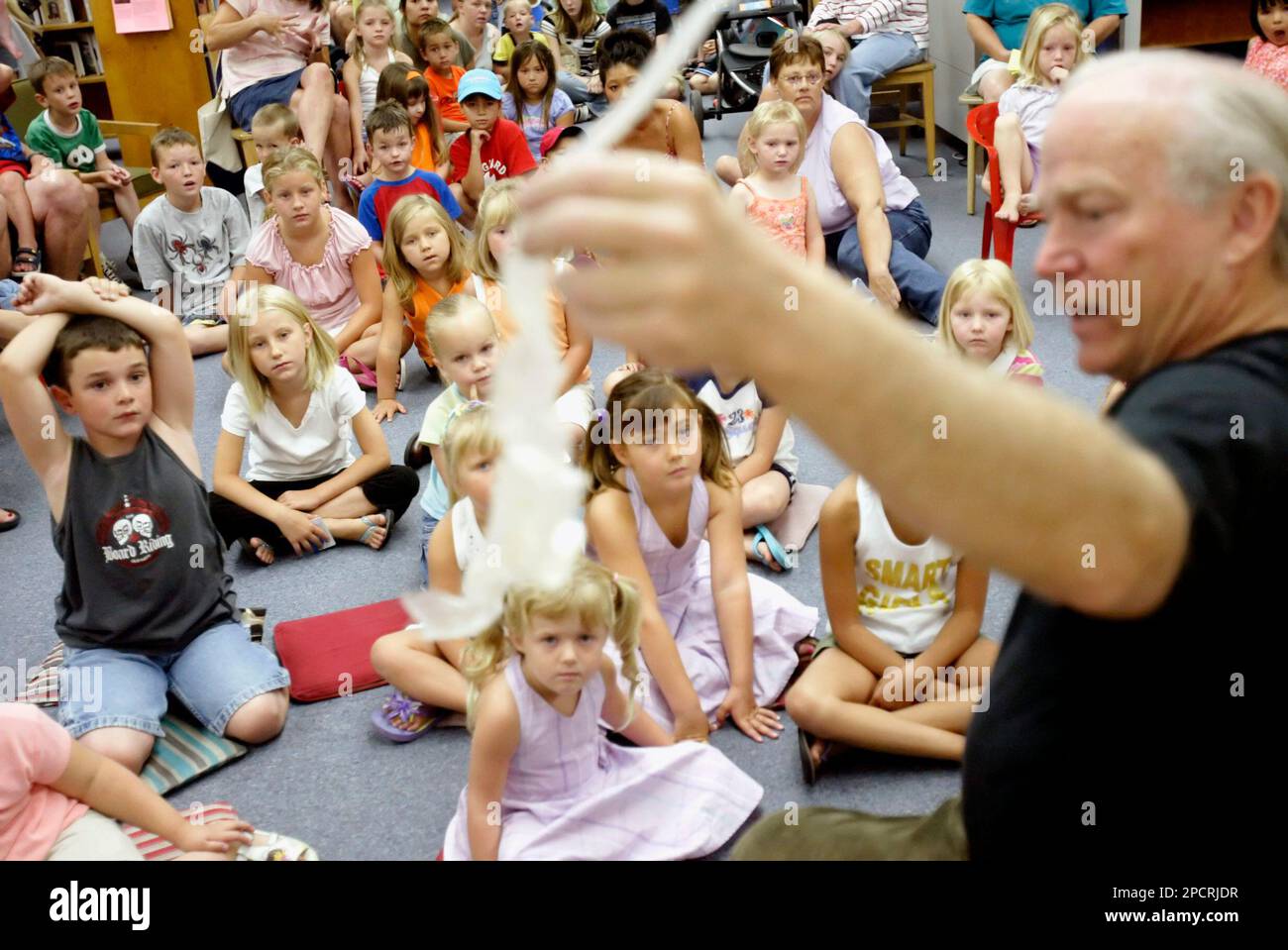 Selah librarian, Michael Martin, holds up skin shed by Bonnie, a four ...