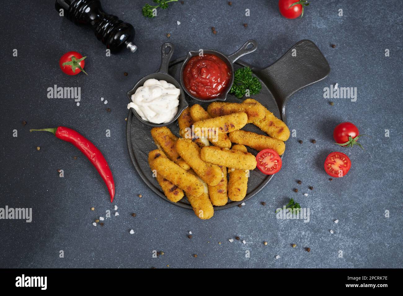 Cooked Mozzarella Cheese sticks with tartar and red tomato sauces on a ...